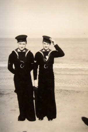 Two young men in Navy sailor suits standing on a beach. 802052 ...